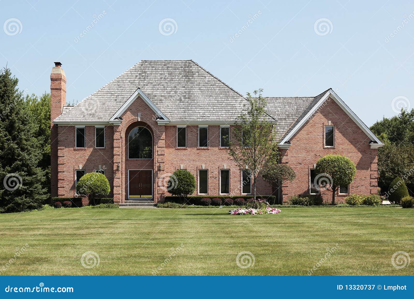 Luxury Brick Home with Arched Entry Stock Image - Image of driveway ...