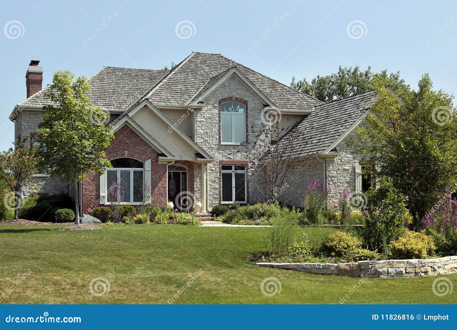 Luxury Brick Home with Stone Terrace Stock Photo - Image of driveway ...