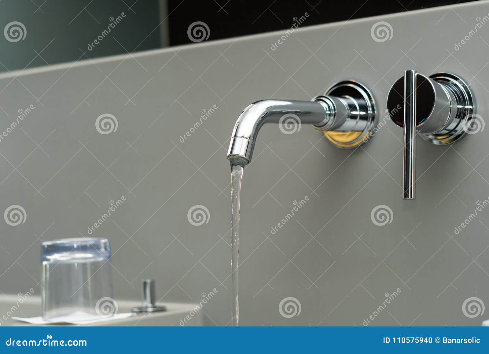 Luxury, Design Water Tap with Flowing Water on Silver Wall. Stock Photo ...