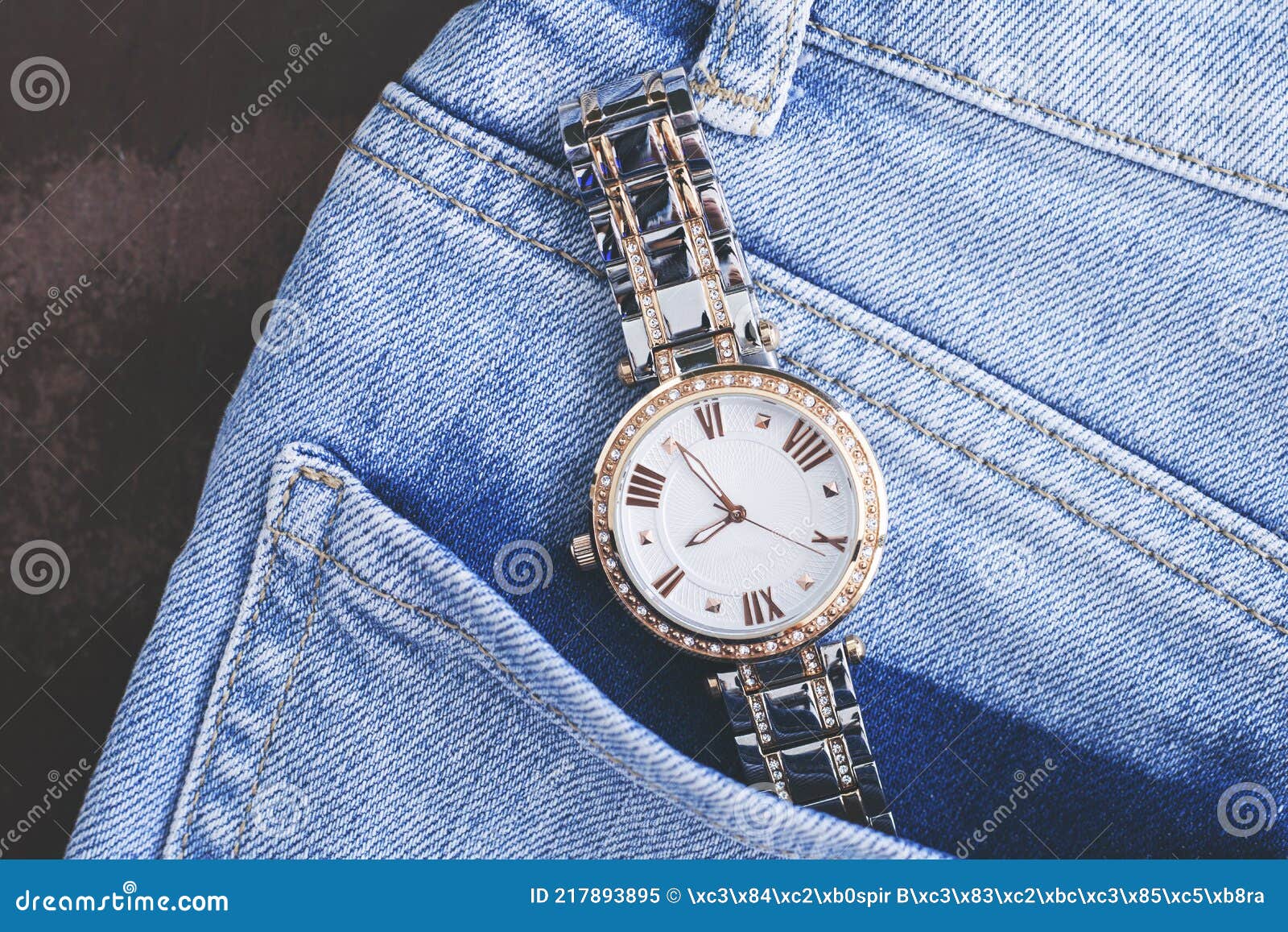 Luxury watch on blue jeans stock image. Image of automatic - 217893895