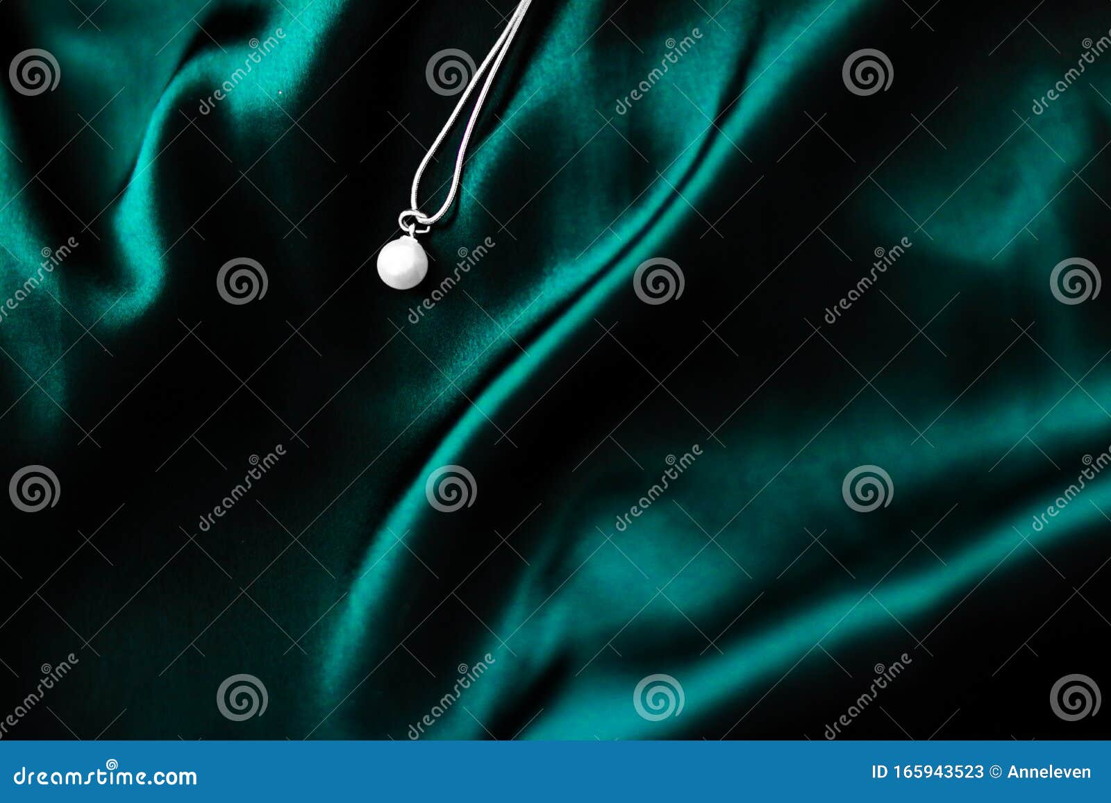 Luxury White Gold Pearl Necklace On Dark Emerald Green Silk Background