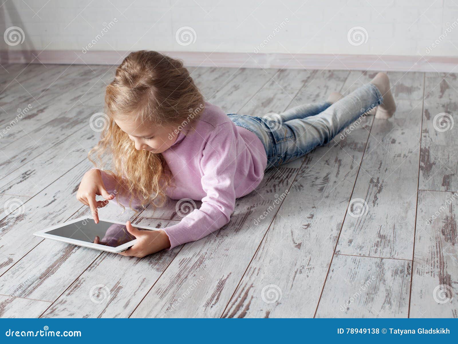 Lying girl with tablet pc stock photo. Image of digital - 78949138