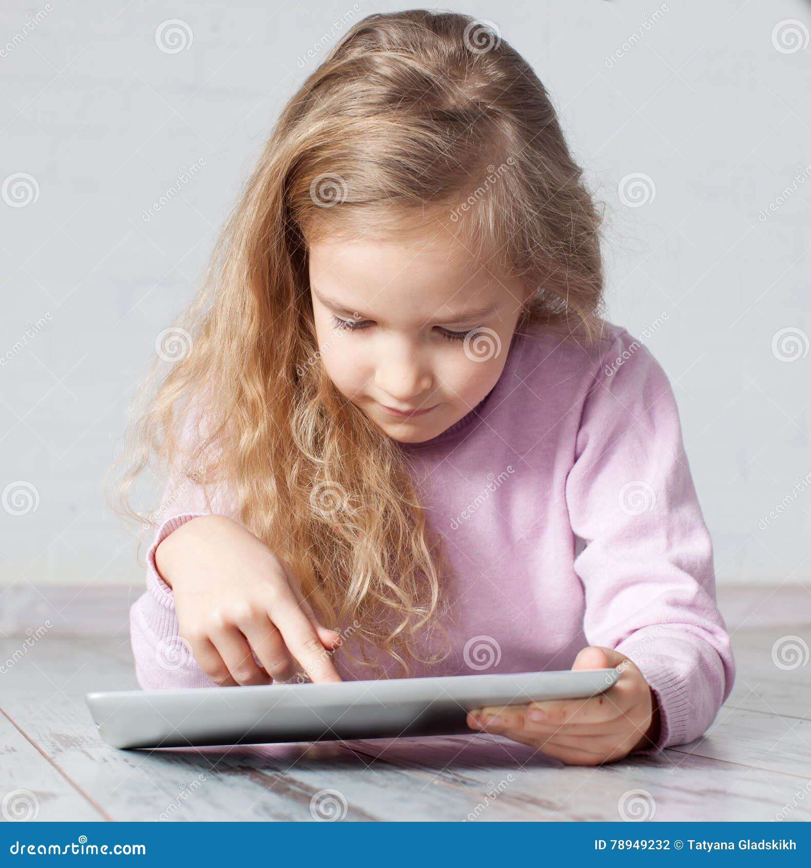 Lying girl with tablet pc stock photo. Image of girl - 78949232