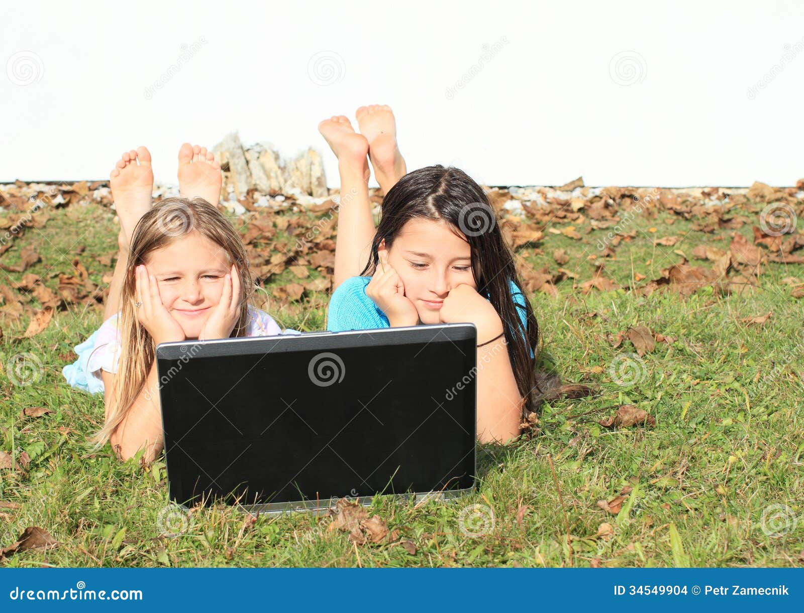 Lying Girls Watching Notebook Stock Photo - Image of interested ...