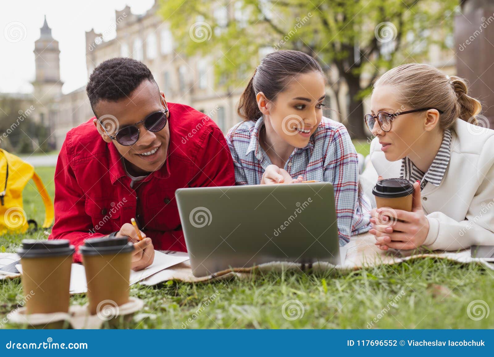 Three Good-looking Students Lying in the Grass Stock Photo - Image of ...