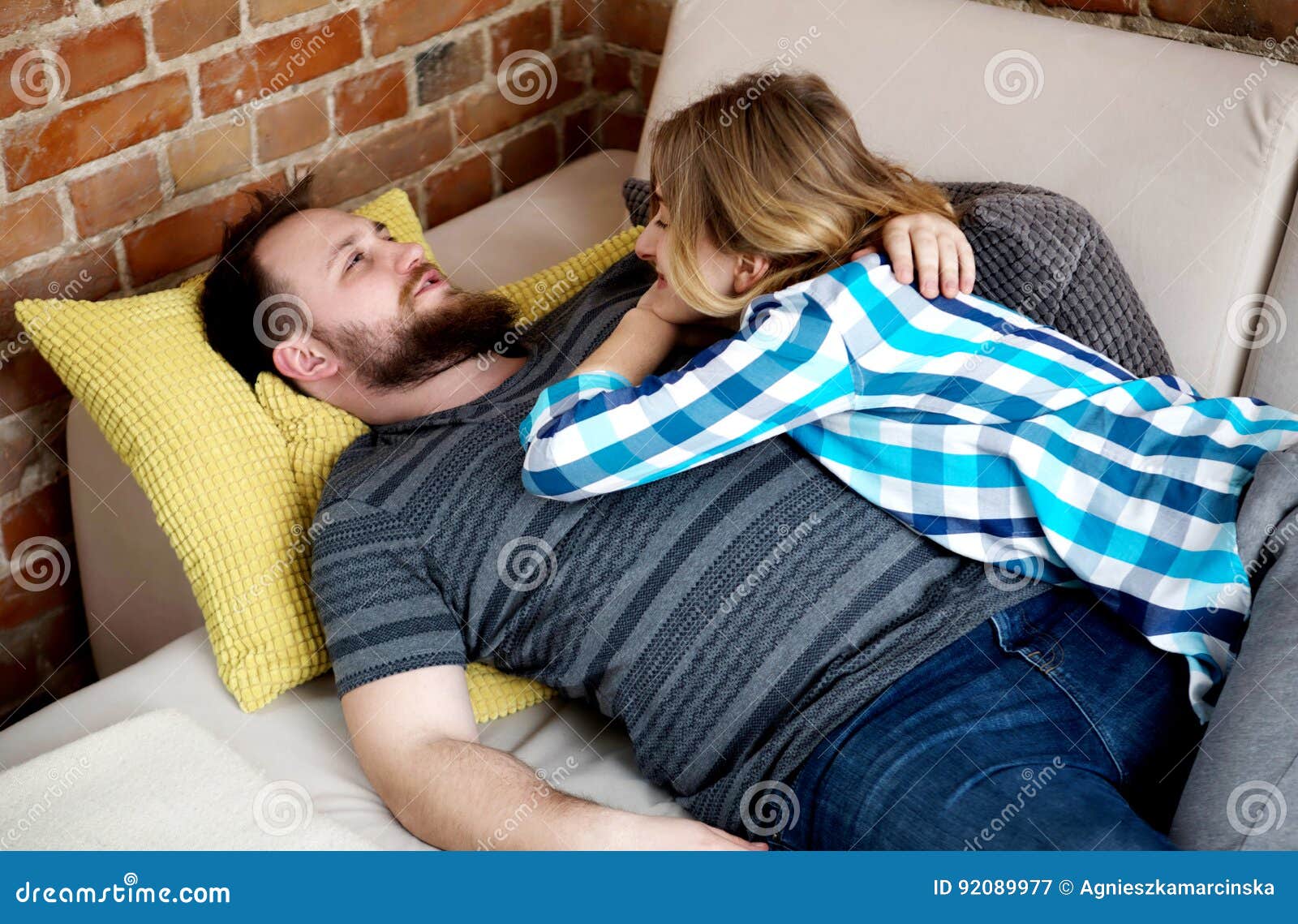 Lying and hugging on sofa. stock image. Image of leisure - 92089977