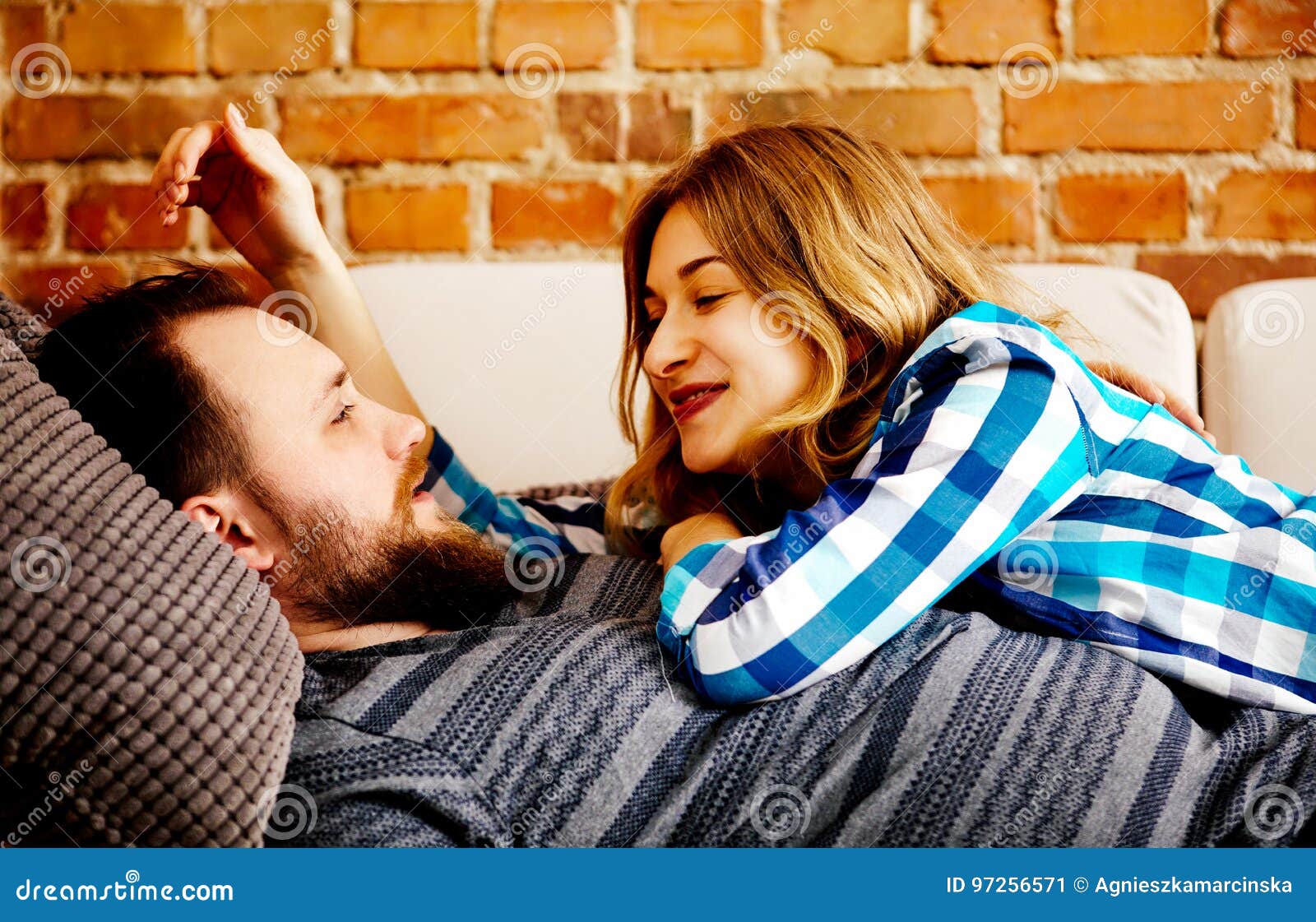 Lying and hugging on sofa. stock image. Image of affection - 97256571