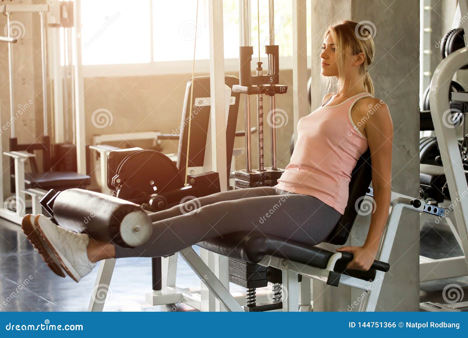 Young Fitness Woman In Sportswear Exercises Open Legs Muscles With Push