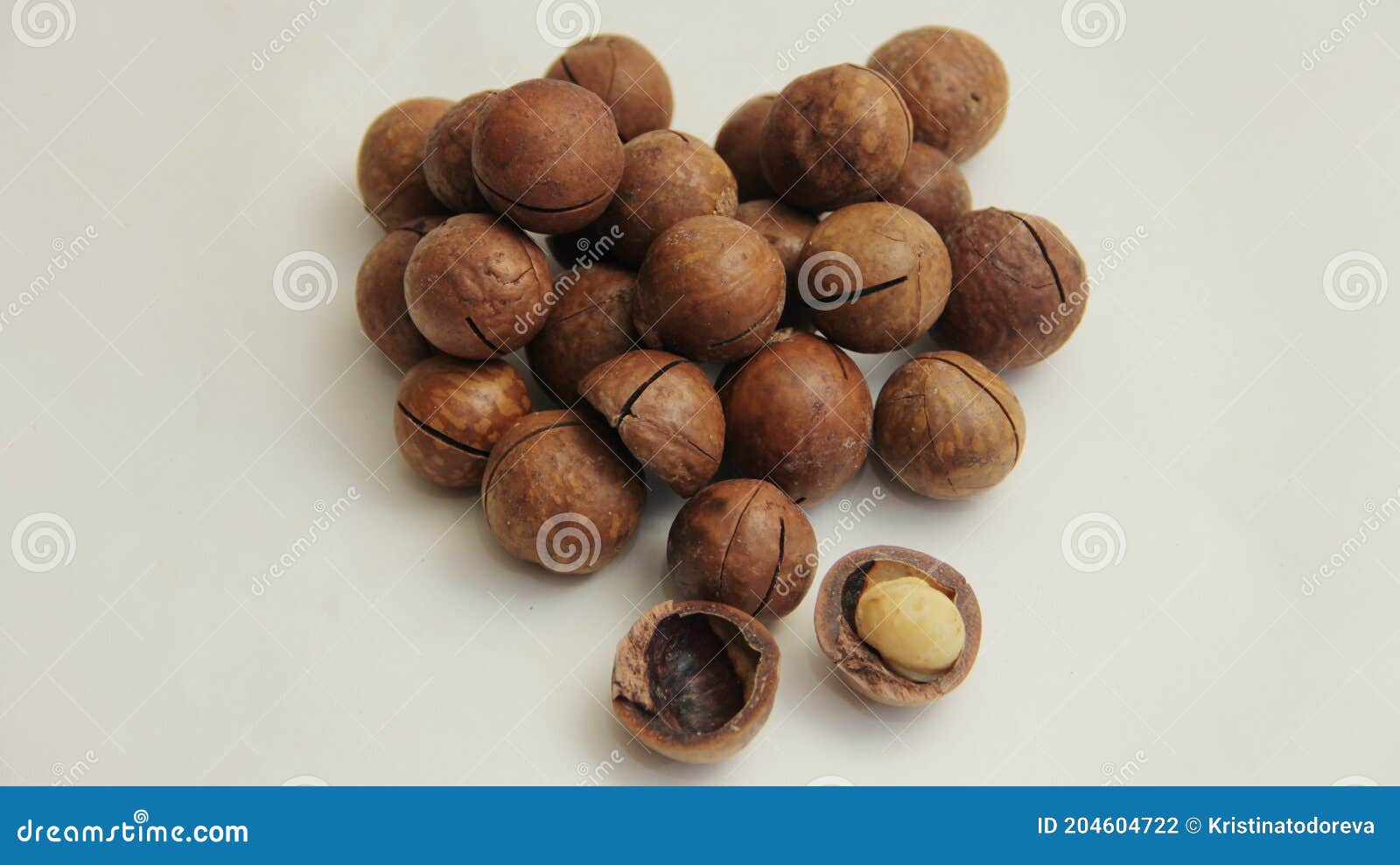 Macadamia Nuts Whole and One Split and a Metal Key on a White ...