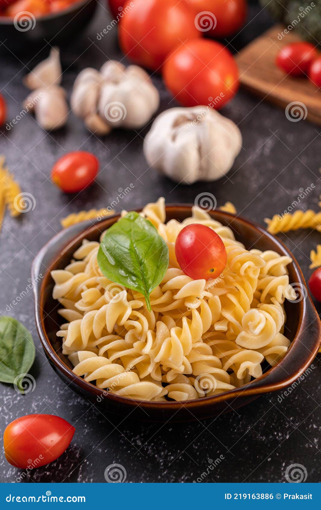 Macaroni Sauteed with Tomatoes and Basil on a Gray Plate Stock Photo ...