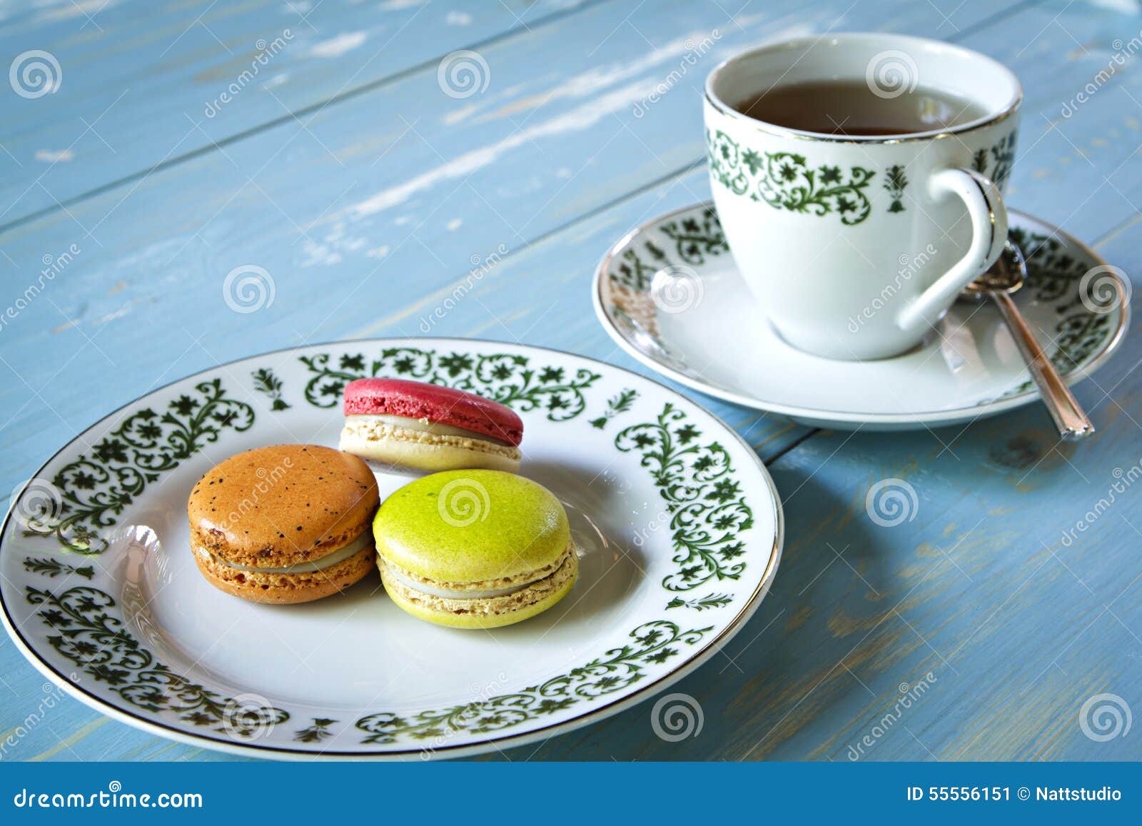 Macarons with a cup of tea stock image. Image of cake - 55556151