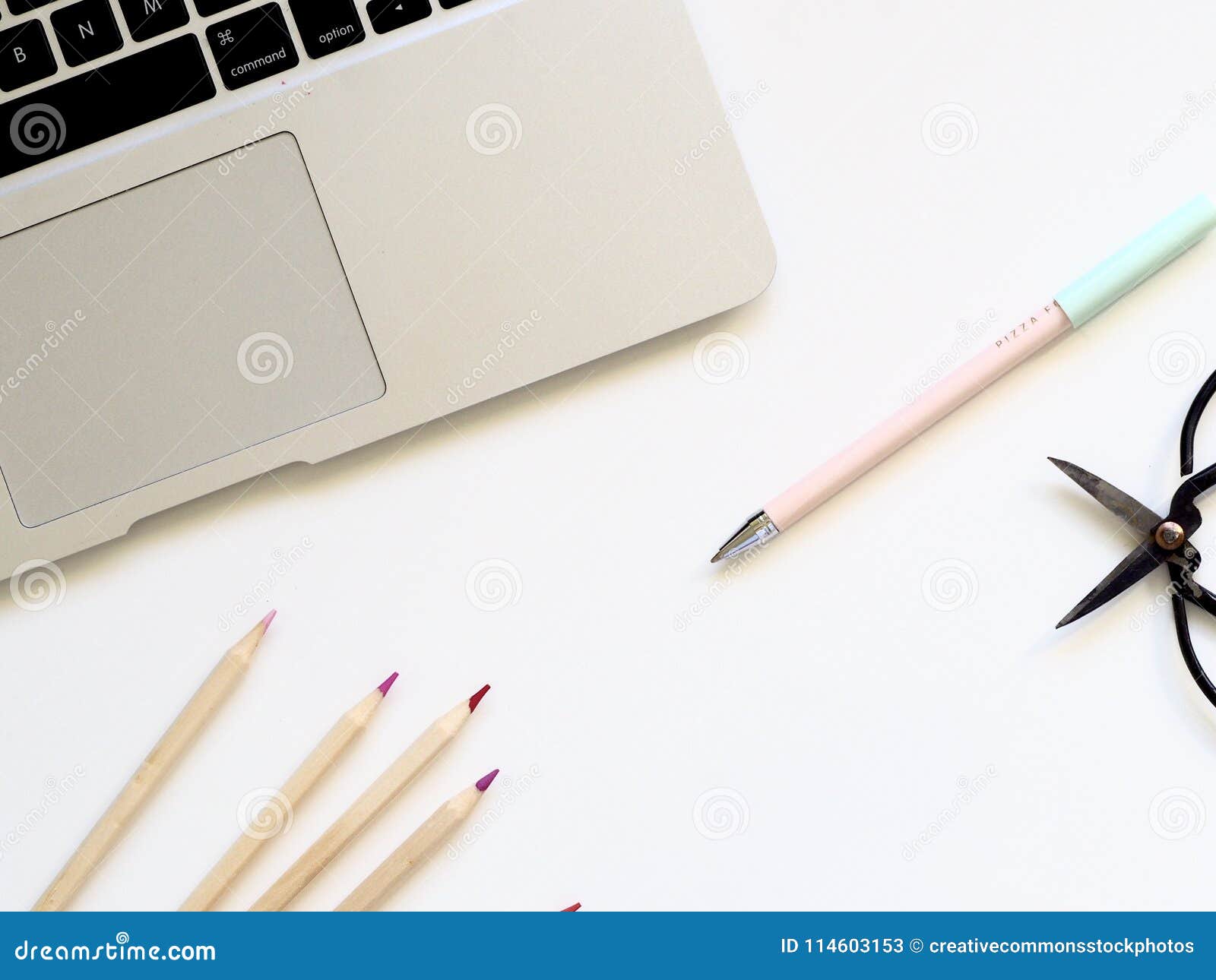 Macbook Pro And Pink Pen On Table Picture. Image: 114603153