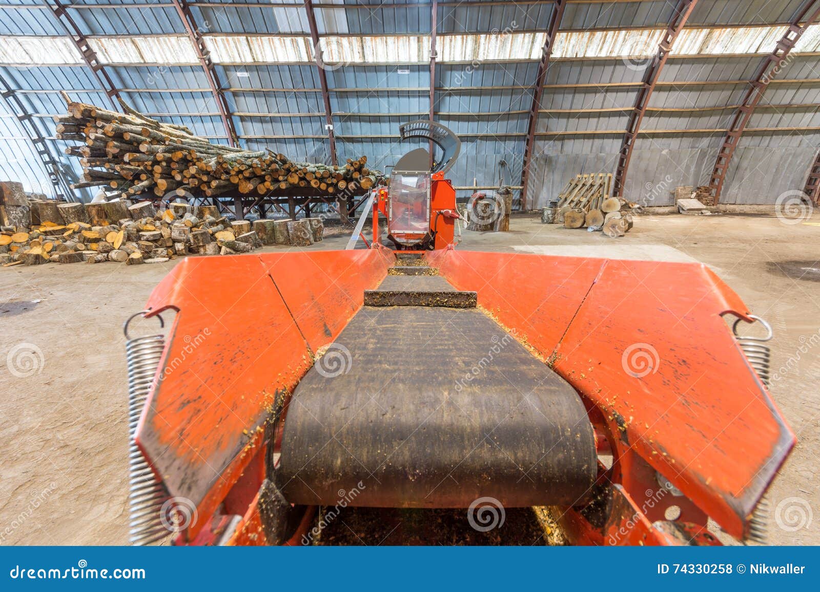 Machine for Chopping Firewood. Firewood Processor in Big Warehouse ...