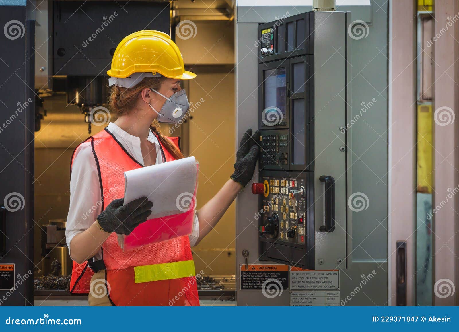 Machine Control Worker at Control Panel Operating CNC Lathe Machine in ...