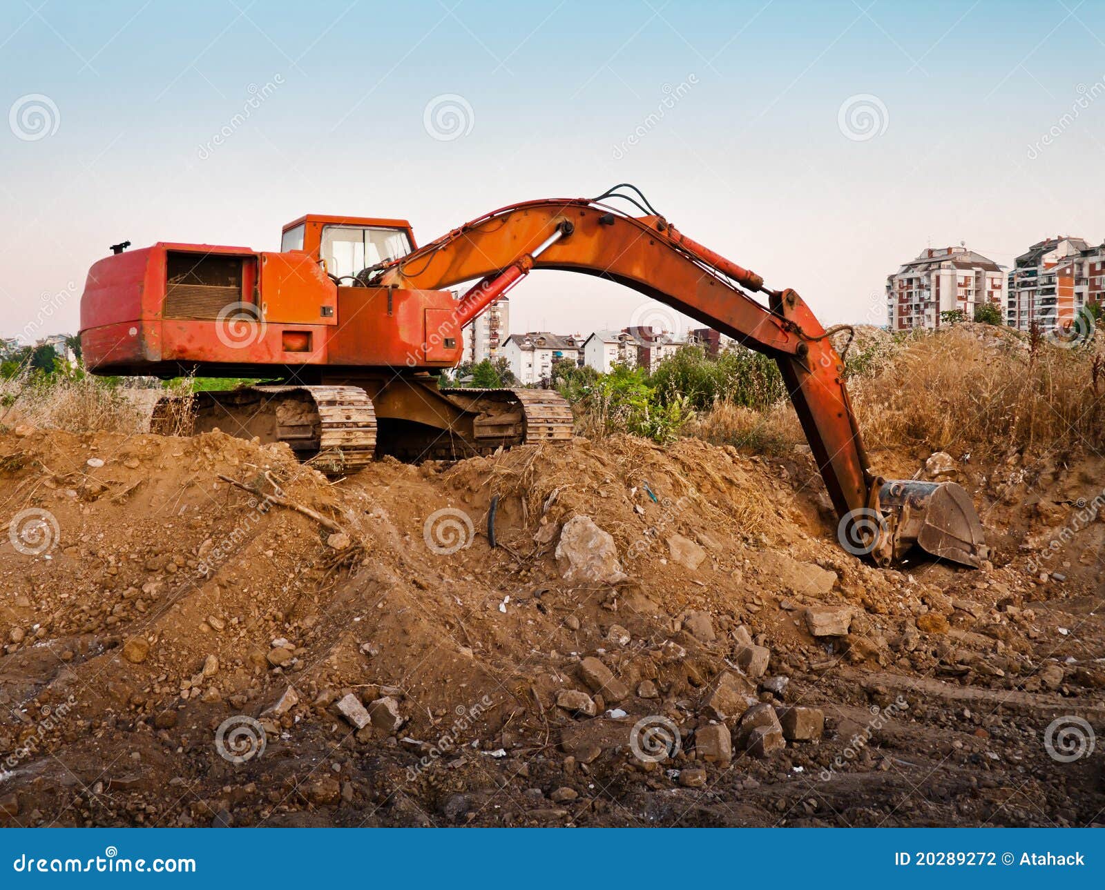 Machine Excavating Earth Near City Stock Photo - Image of bulldozer ...