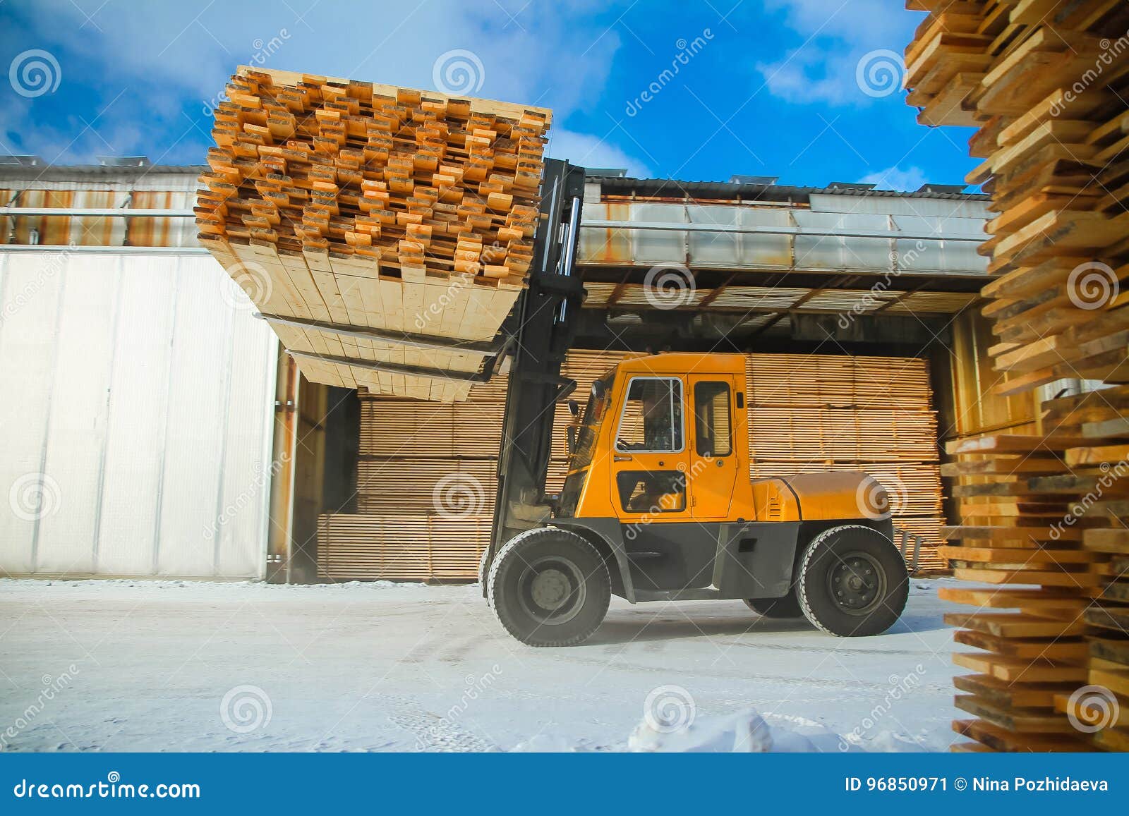 Machine is lifting lumber stock image. Image of construction - 96850971