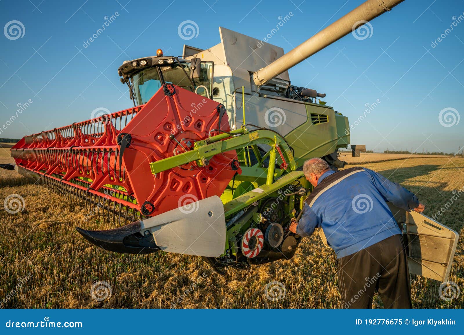 The Machine Operator in the Field Checks the Mechanisms of the Combine ...