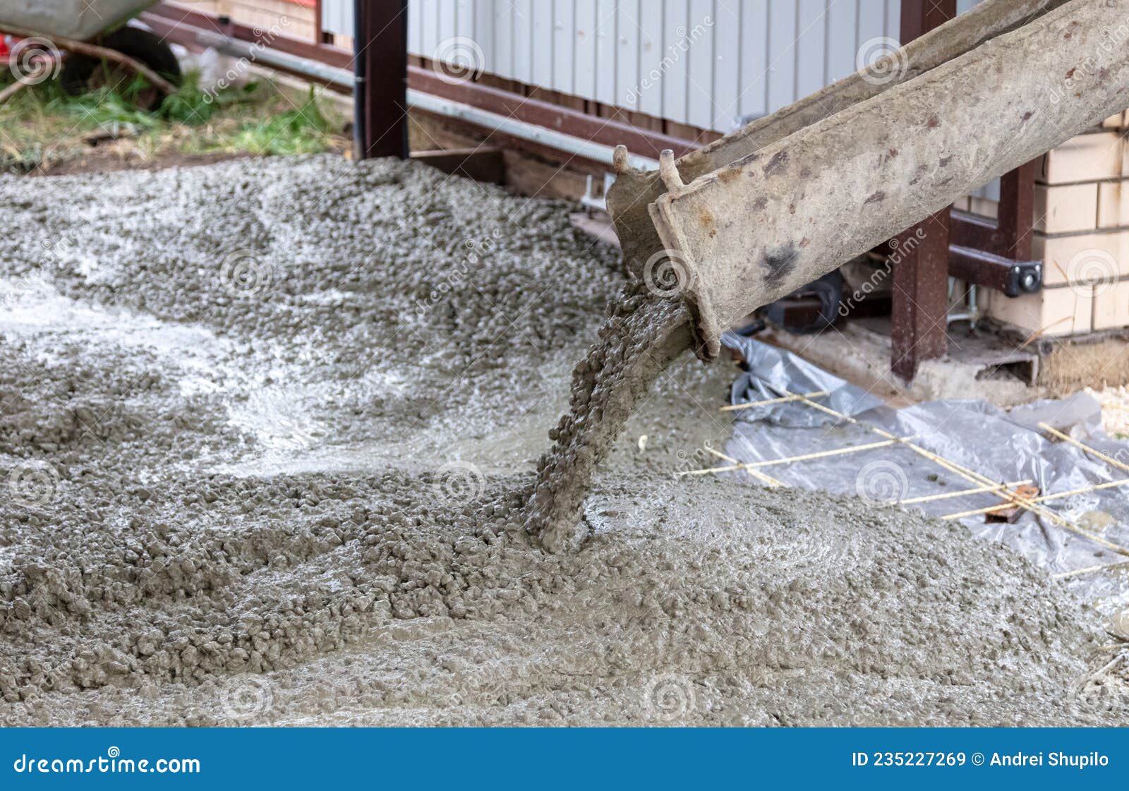 The Machine is Pouring Concrete Mix at a Construction Site. Stock Image ...