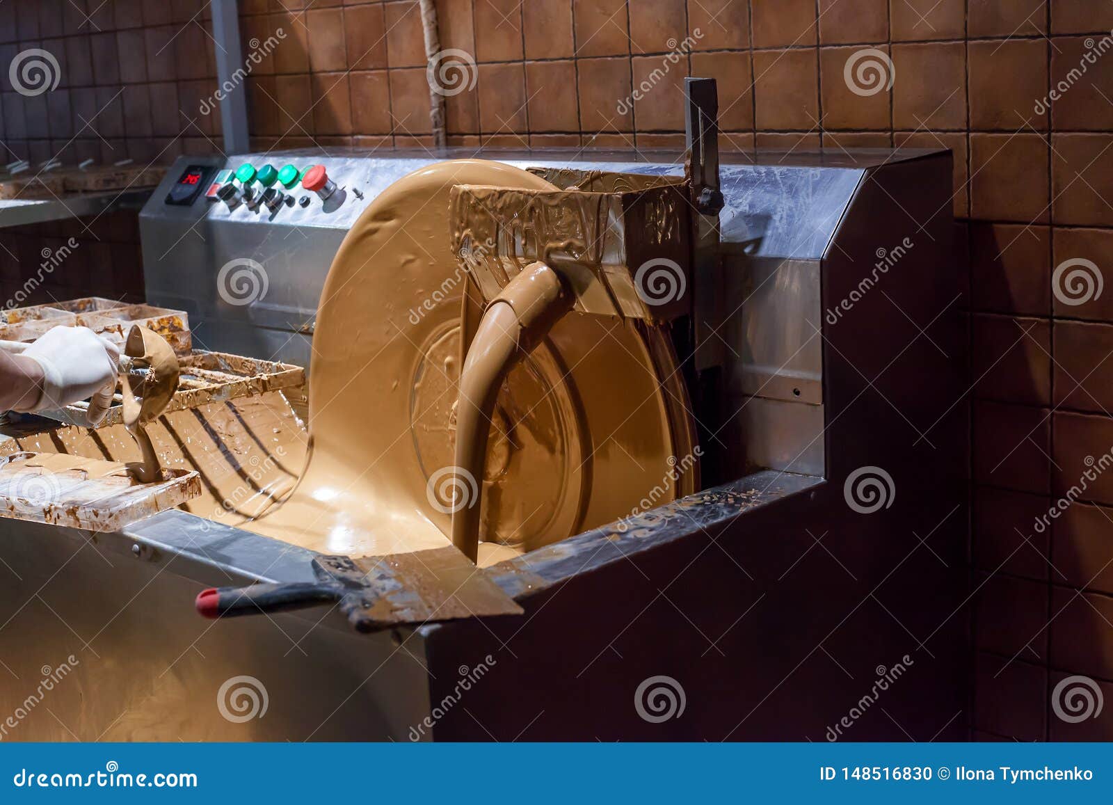 Machine Processes and Creation Chocolate. Pouring Milk Chocolate Stock ...