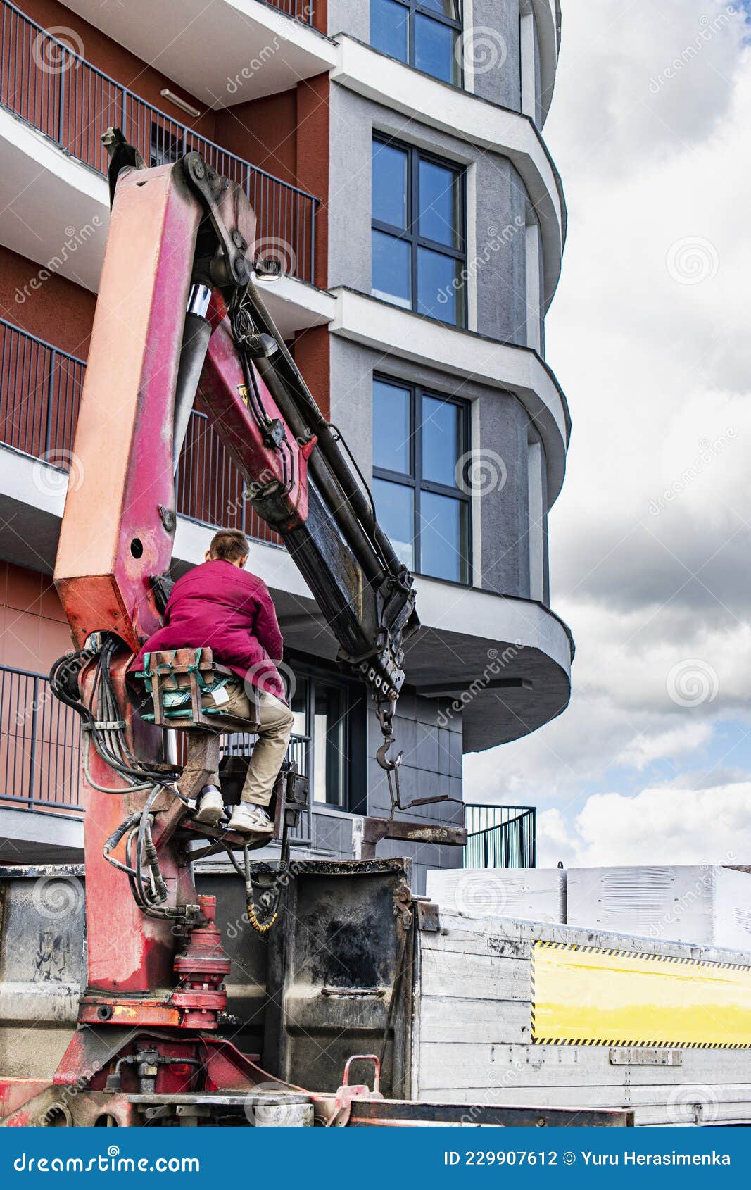 A Machine Truck with a Loader Crane Unloads Blocks for Building a House ...