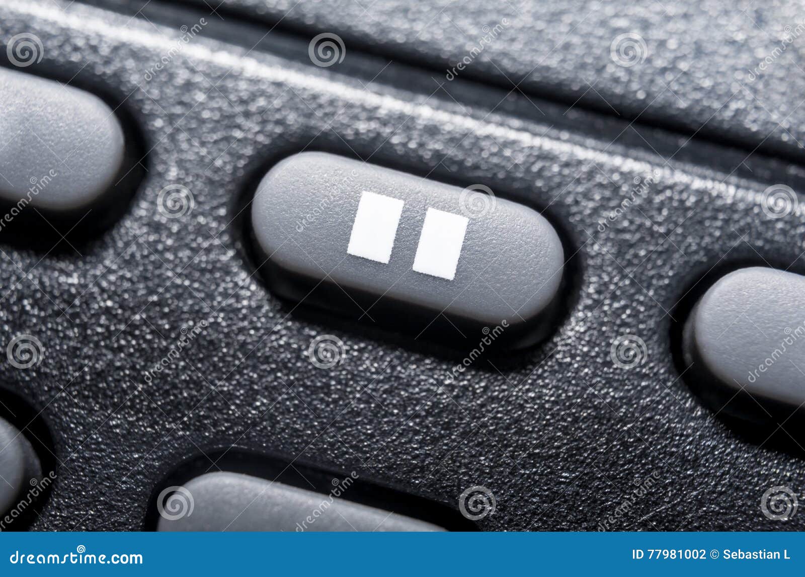 Macro of a Black Pause Button on Black Remote Control for a Hifi Stereo ...
