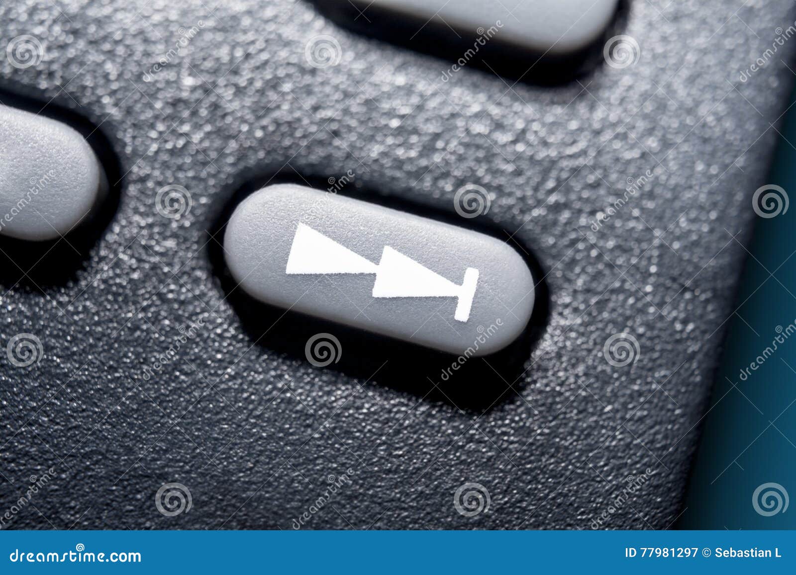 Macro of a Black Skip Forward Button on Black Remote Control for a Hifi ...