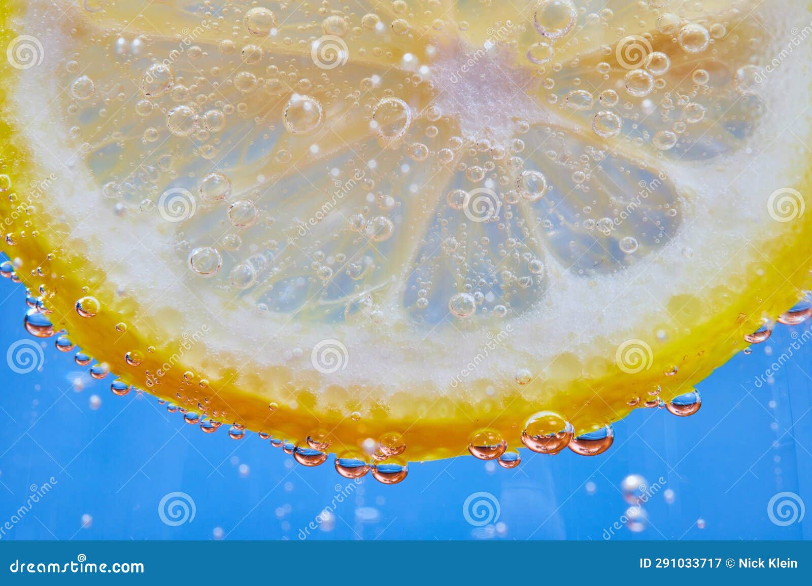 Macro of Bubbles on Curved Edge of Yellow Lemon Slice with Blue ...