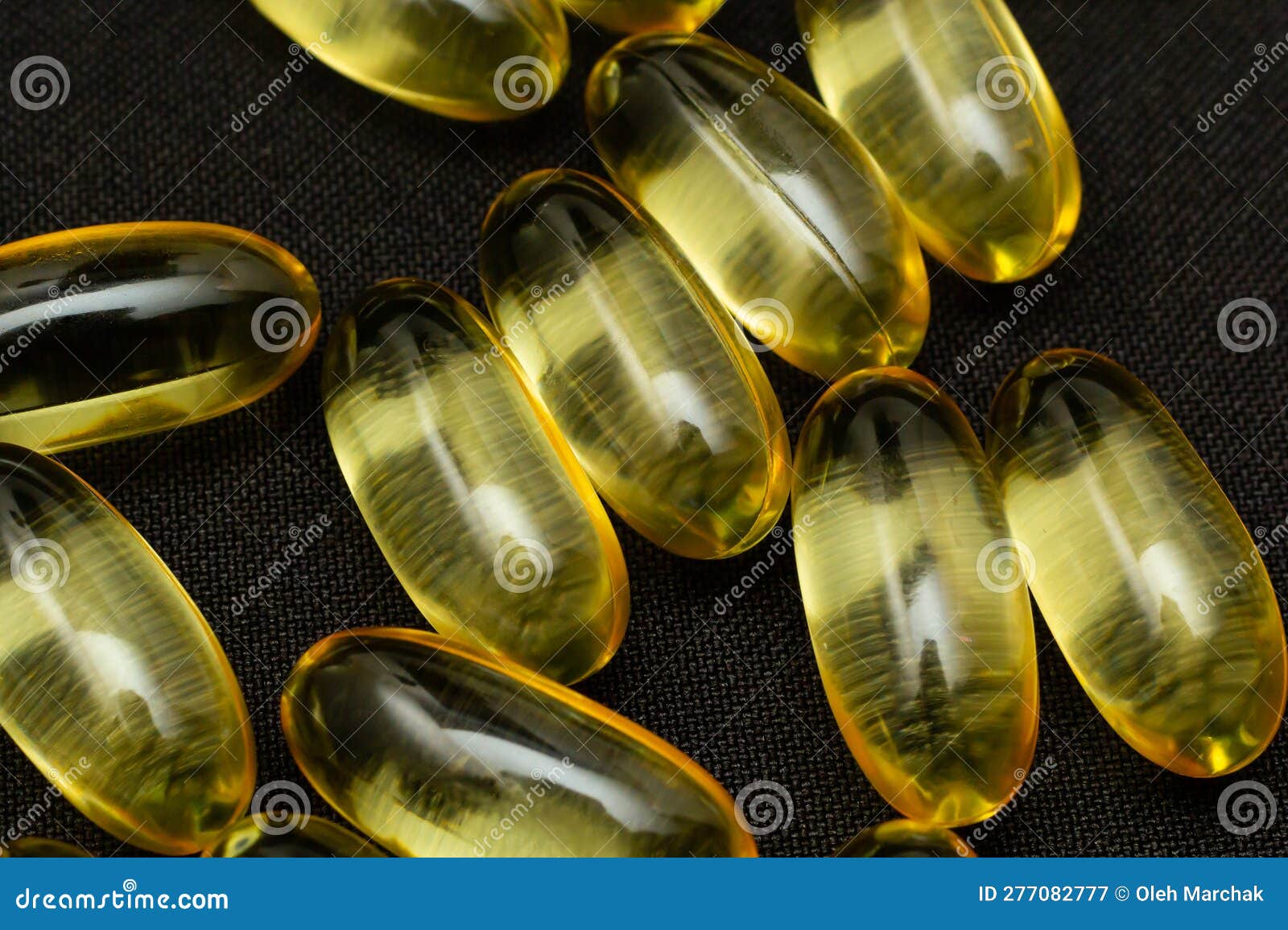 Macro Close Up of Omega 3 Gel Capsule on a Reflective Black Background ...