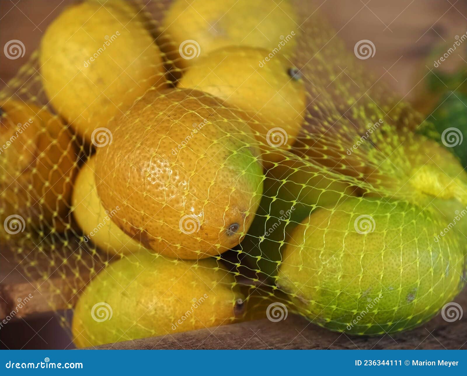 Macro of Fresh Lemons in a Net on a Wooden Board Stock Image - Image of ...