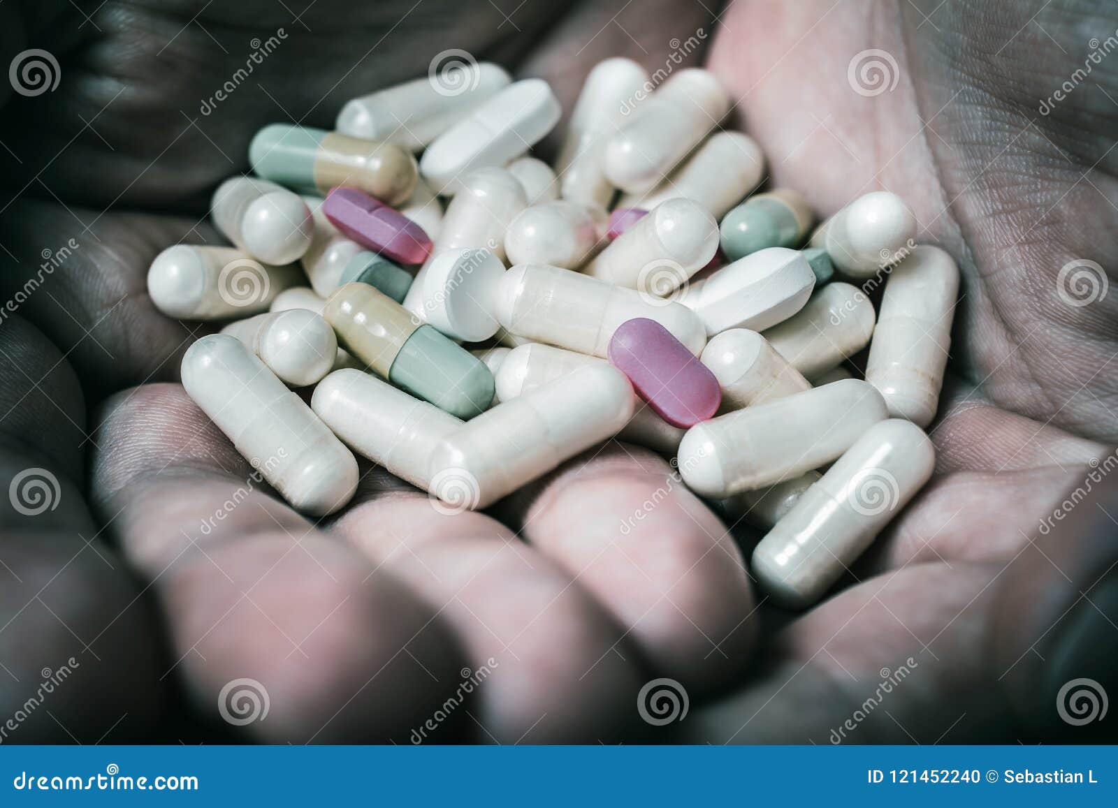 Macro of 2 Hands Holding Several Pills in a Dark Atmosphere - Taking ...
