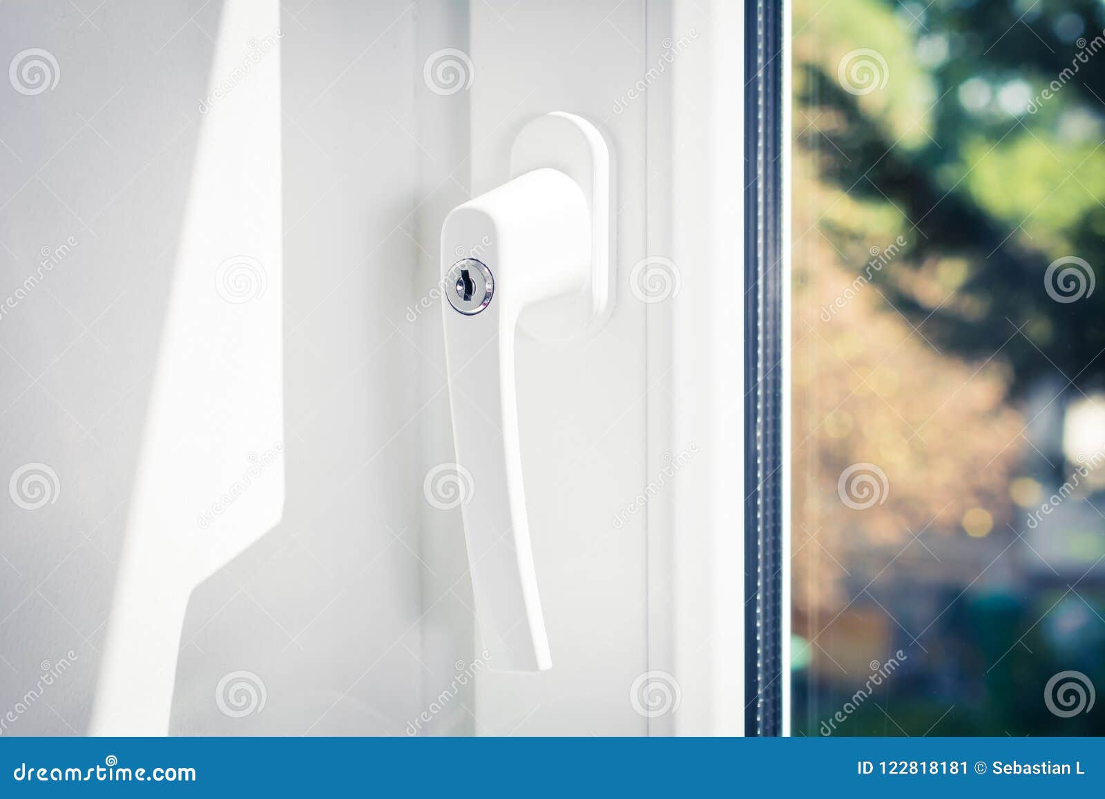 Macro of a Lockable Window Handle of a Closed White Window with Trees ...