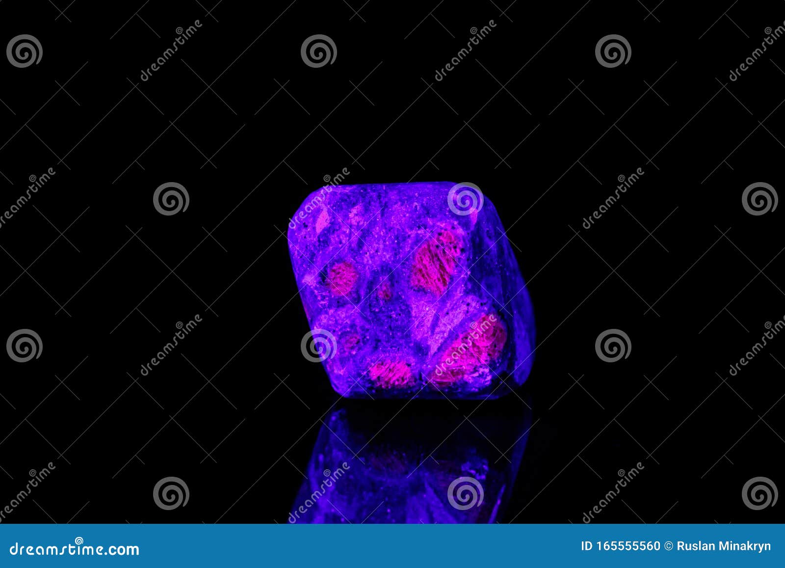 Macro Mineral Stone Ruby Under Ultraviolet Light on a Black Background ...
