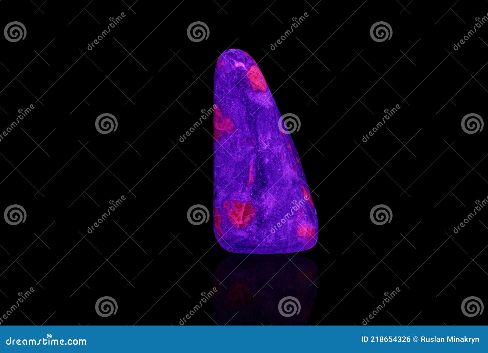 Macro Mineral Stone Ruby Under Ultraviolet Light on a Black Background ...