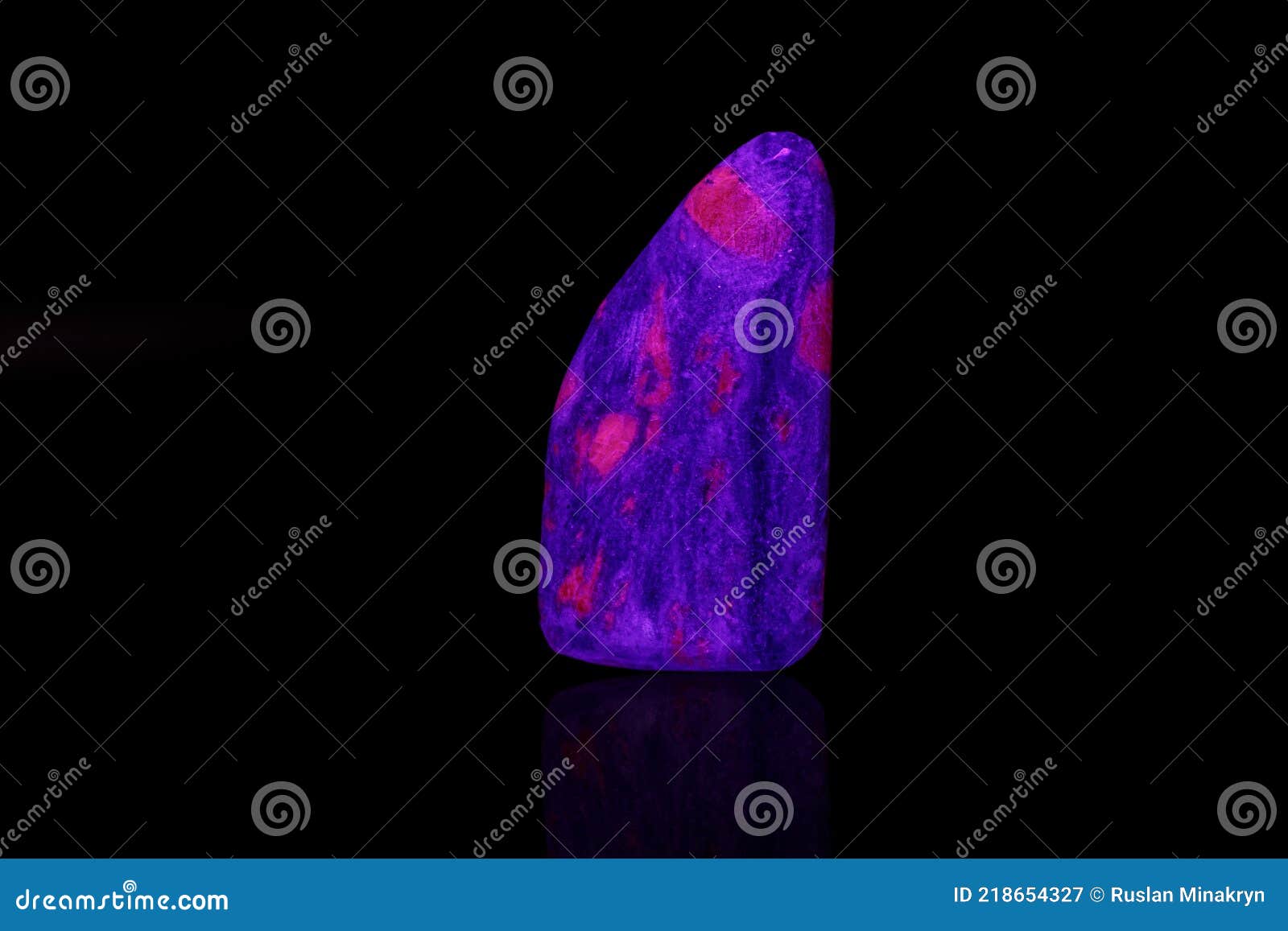 Macro Mineral Stone Ruby Under Ultraviolet Light on a Black Background ...