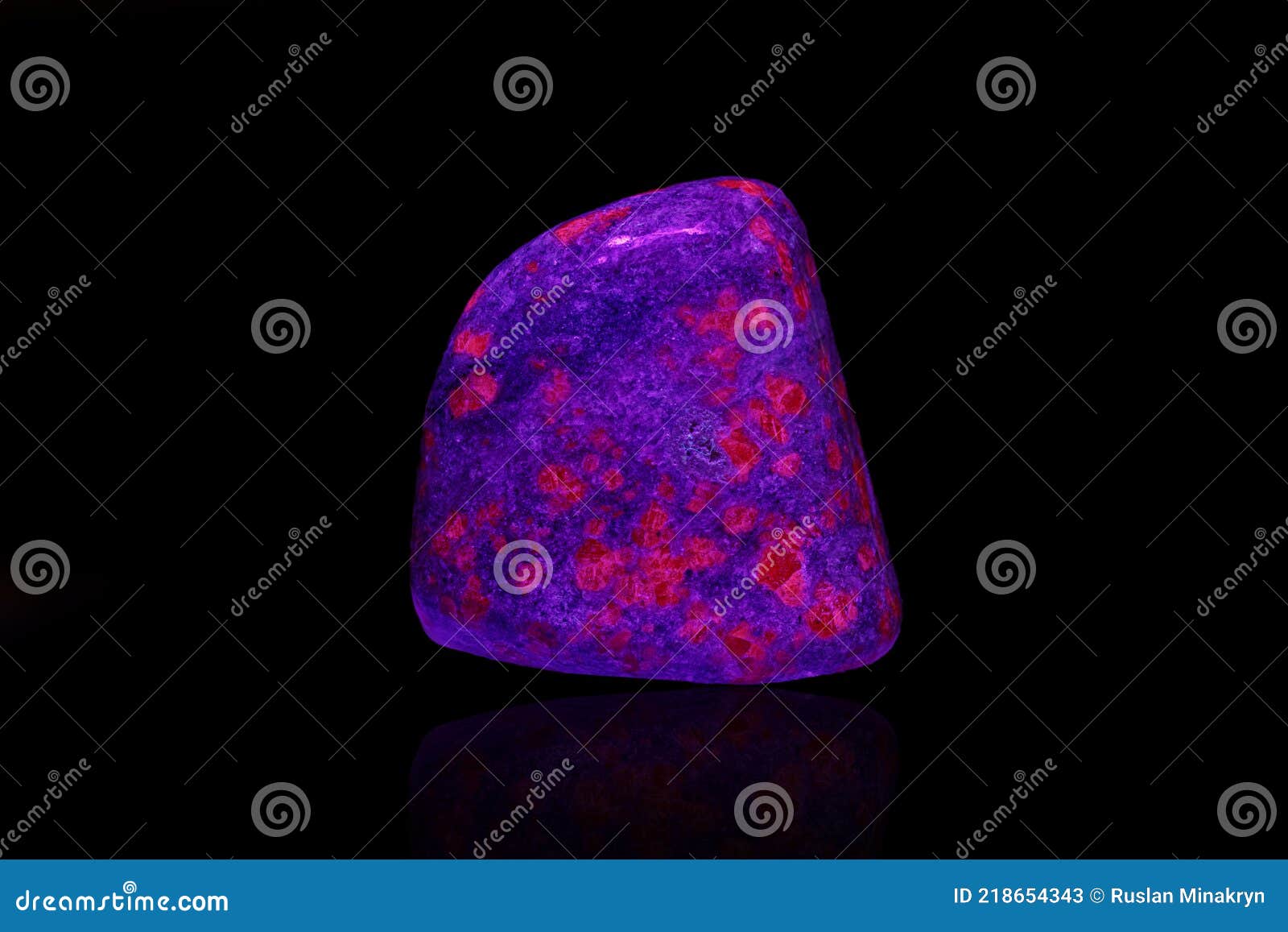 Macro Mineral Stone Ruby Under Ultraviolet Light on a Black Background ...