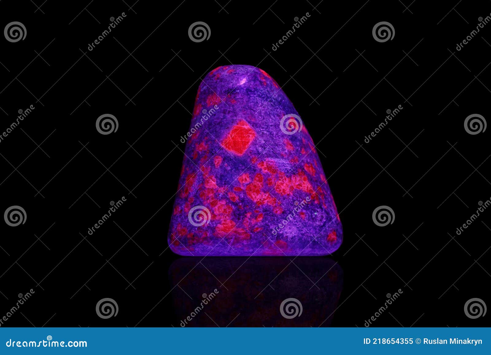 Macro Mineral Stone Ruby Under Ultraviolet Light on a Black Background ...