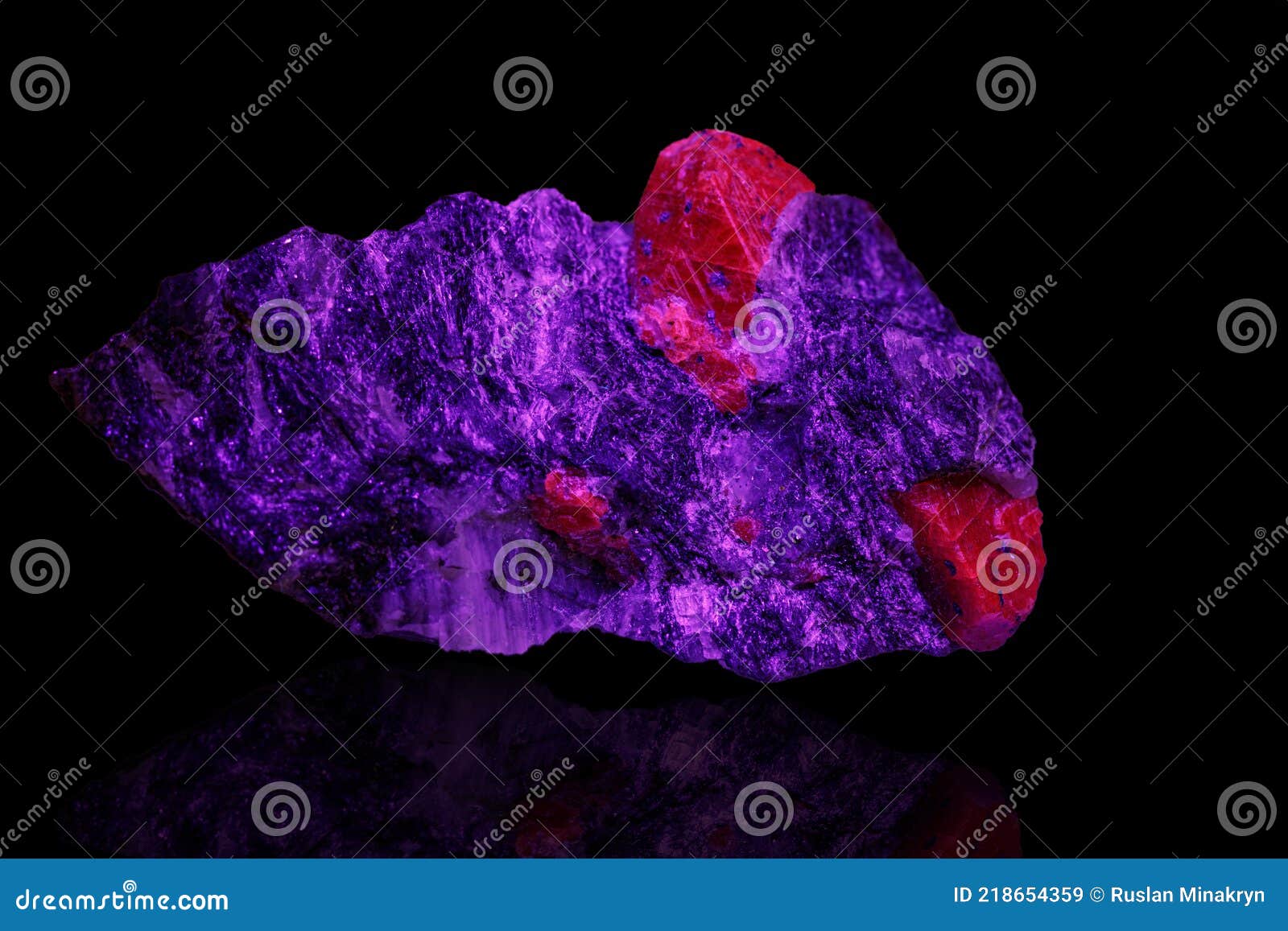 Macro Mineral Stone Ruby Under Ultraviolet Light on a Black Background ...