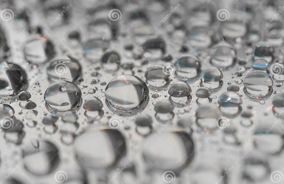 Macro Photography of Water Drops on a Mirror Reflective Surface. Stock ...