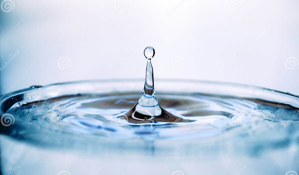 Macro Shot of a Drop of Water Falling into a Glass Cup with Drinking ...
