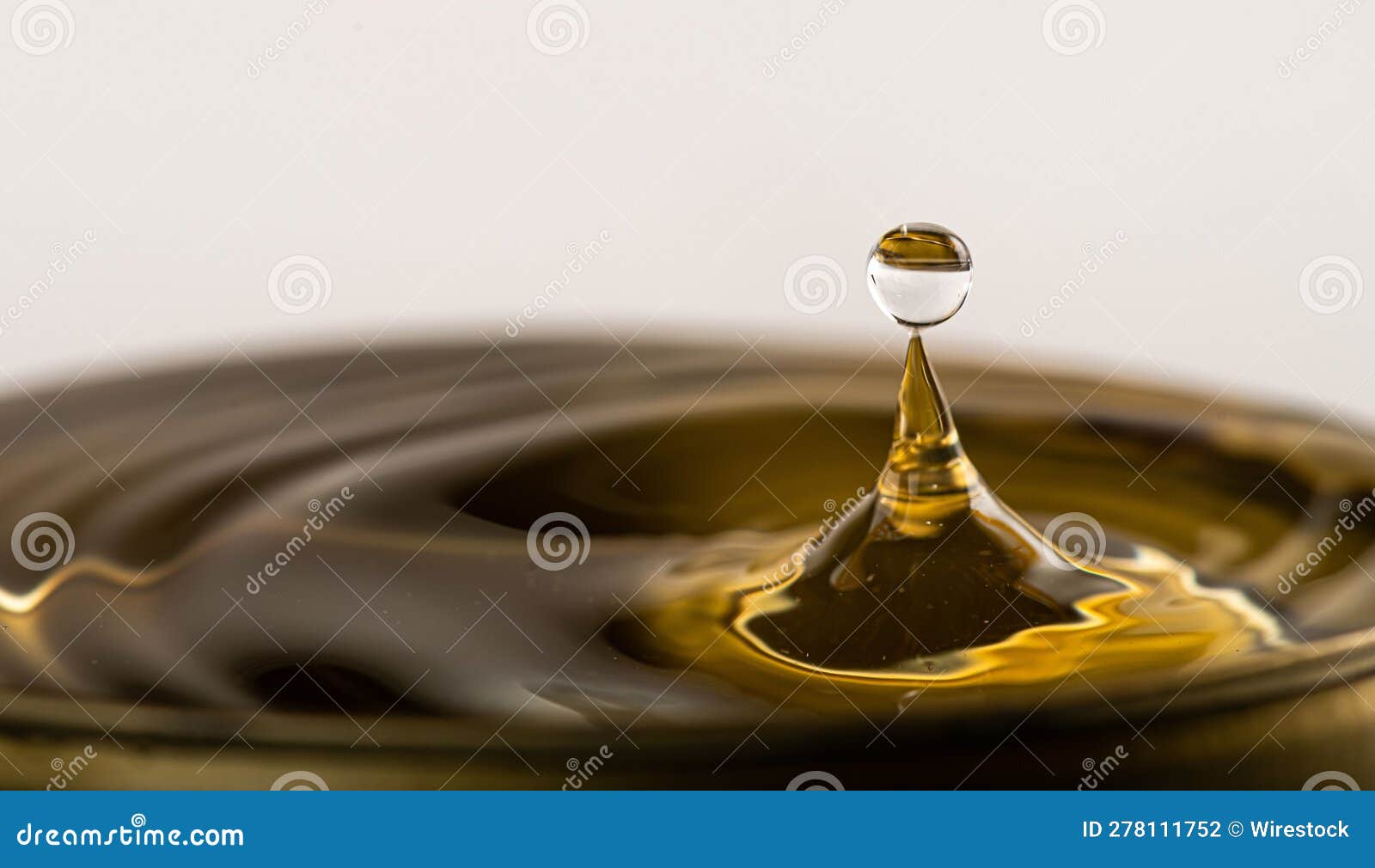 Macro Shot of a Single Drop of Liquid Descending into Liquid Stock ...