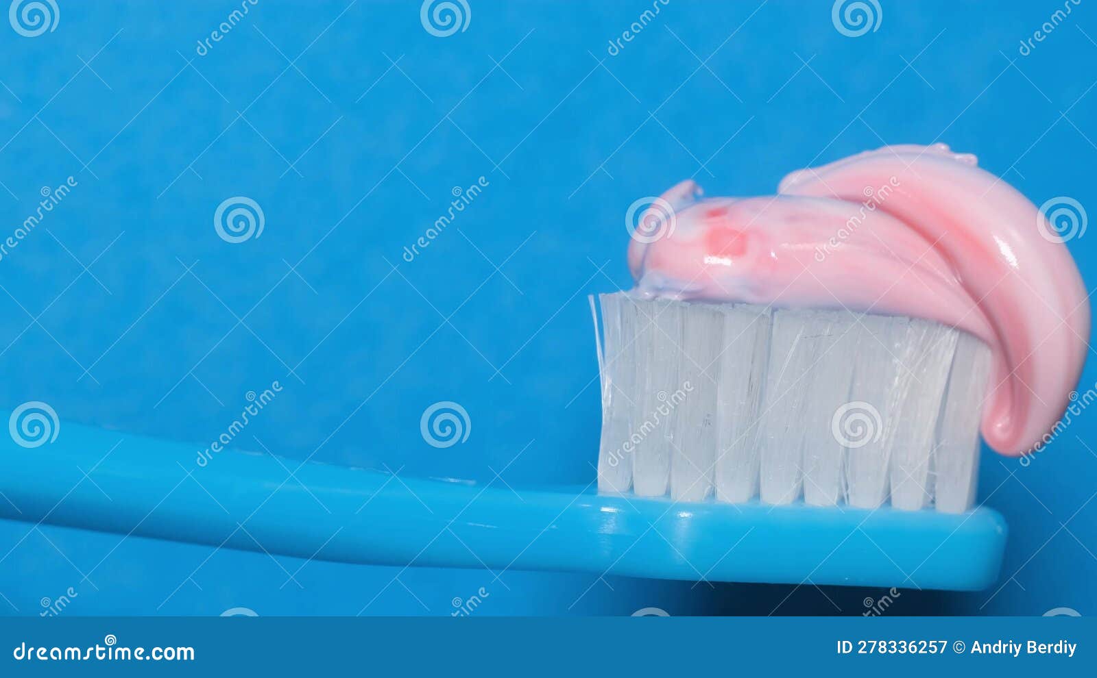 Macro Video of Squeezing Toothpaste Onto a Brush on a Blue Background ...