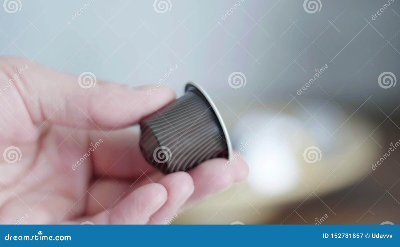 Man`s Hand Holds Small Brown Capsule with Stripes of Automatic Coffee ...