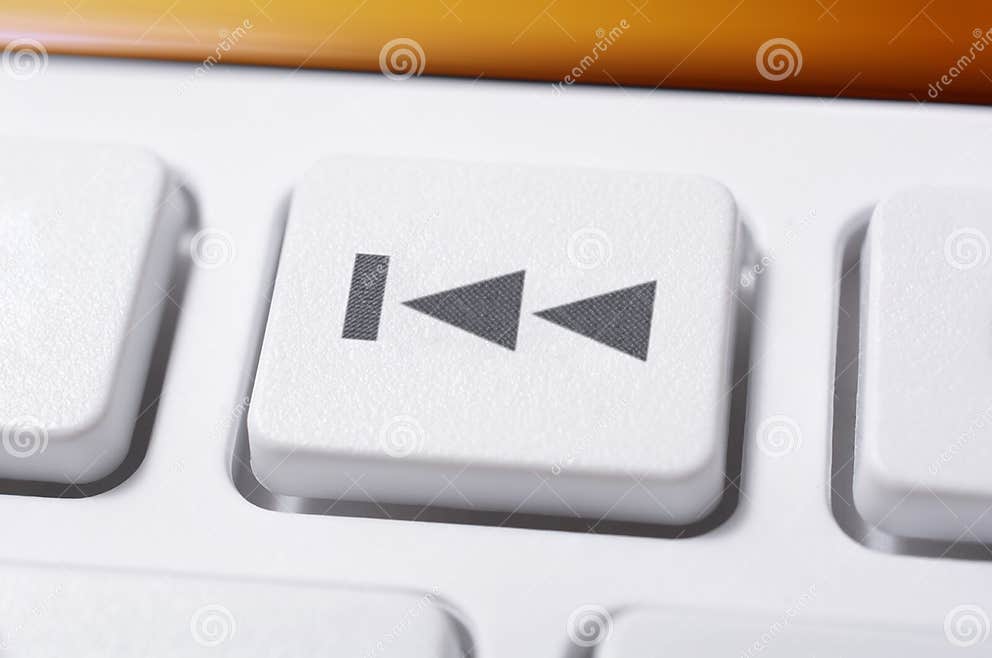 Macro of a White Skip Backward Button of a White Remote Control for a ...