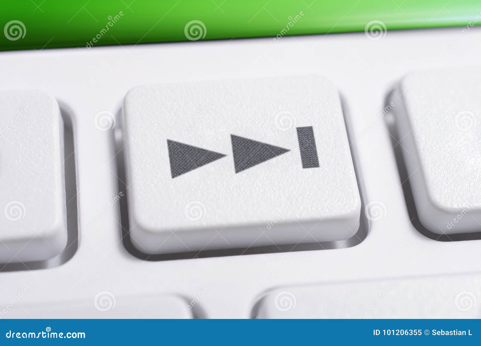 Macro of a White Skip Forward Button of a White Remote Control for a ...