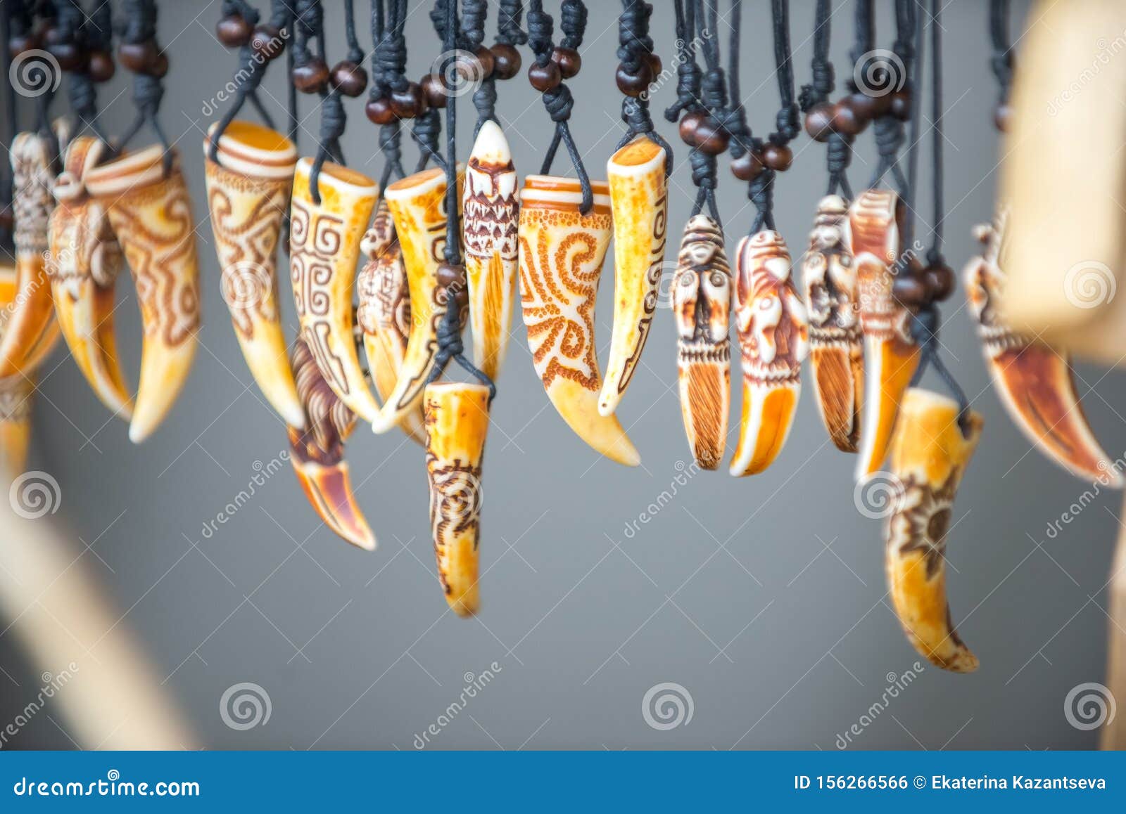 Magic Amulets from Teeth of Animals Hang on Laces on the Stand at the ...