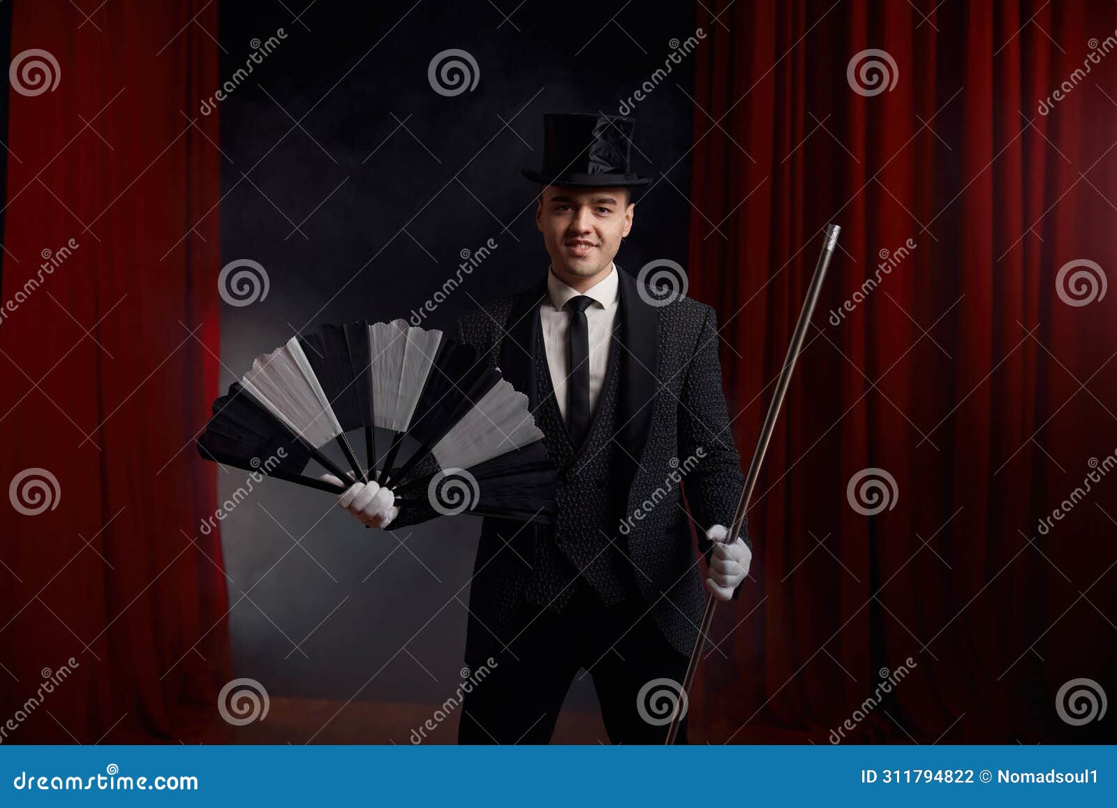 Magician Performing Miracle Trick on Stage Using Fan and Cane Stock ...