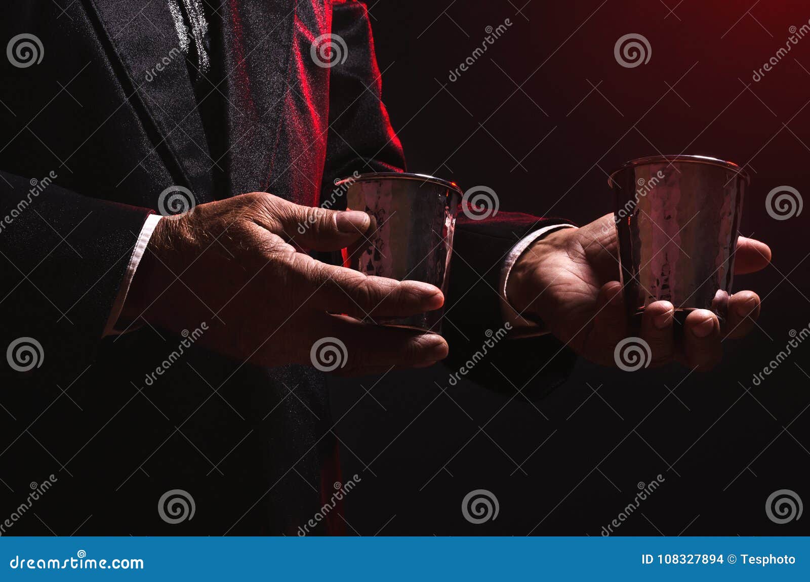 Magician Shows Trick with a Metal Cup. Manipulation with Props. Stock ...