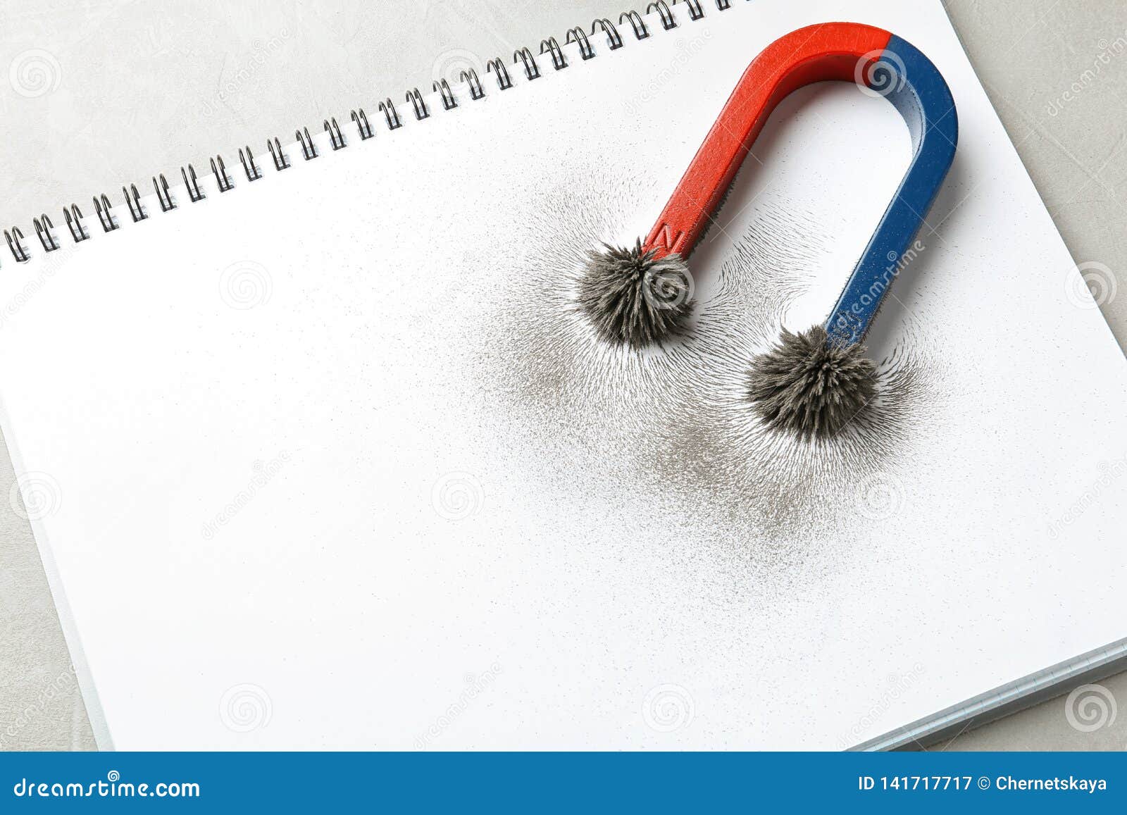 Magnet with Iron Powder on Notebook, Top View. Stock Image - Image of ...