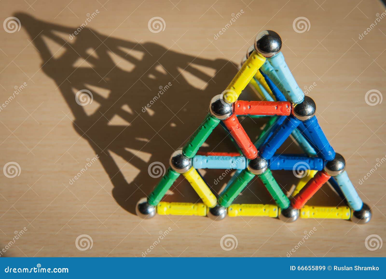 Magnet Toy Pyramid on the Desk with Shadow Stock Image - Image of ...