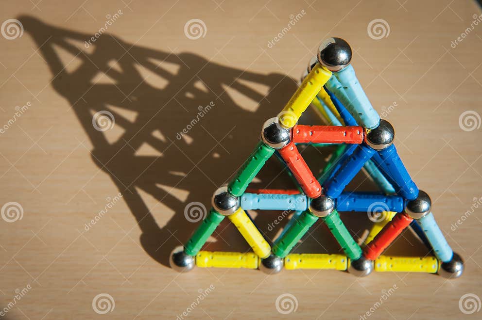 Magnet Toy Pyramid on the Desk with Shadow Stock Image - Image of ...